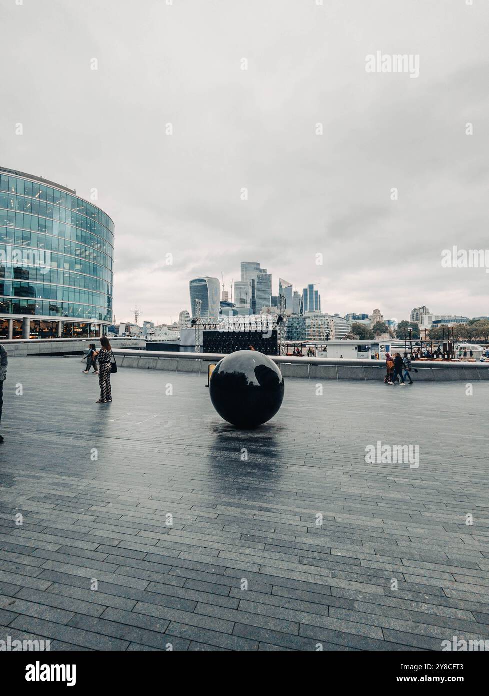 Black concrete ball opposite the City of London on cloudy day Stock ...
