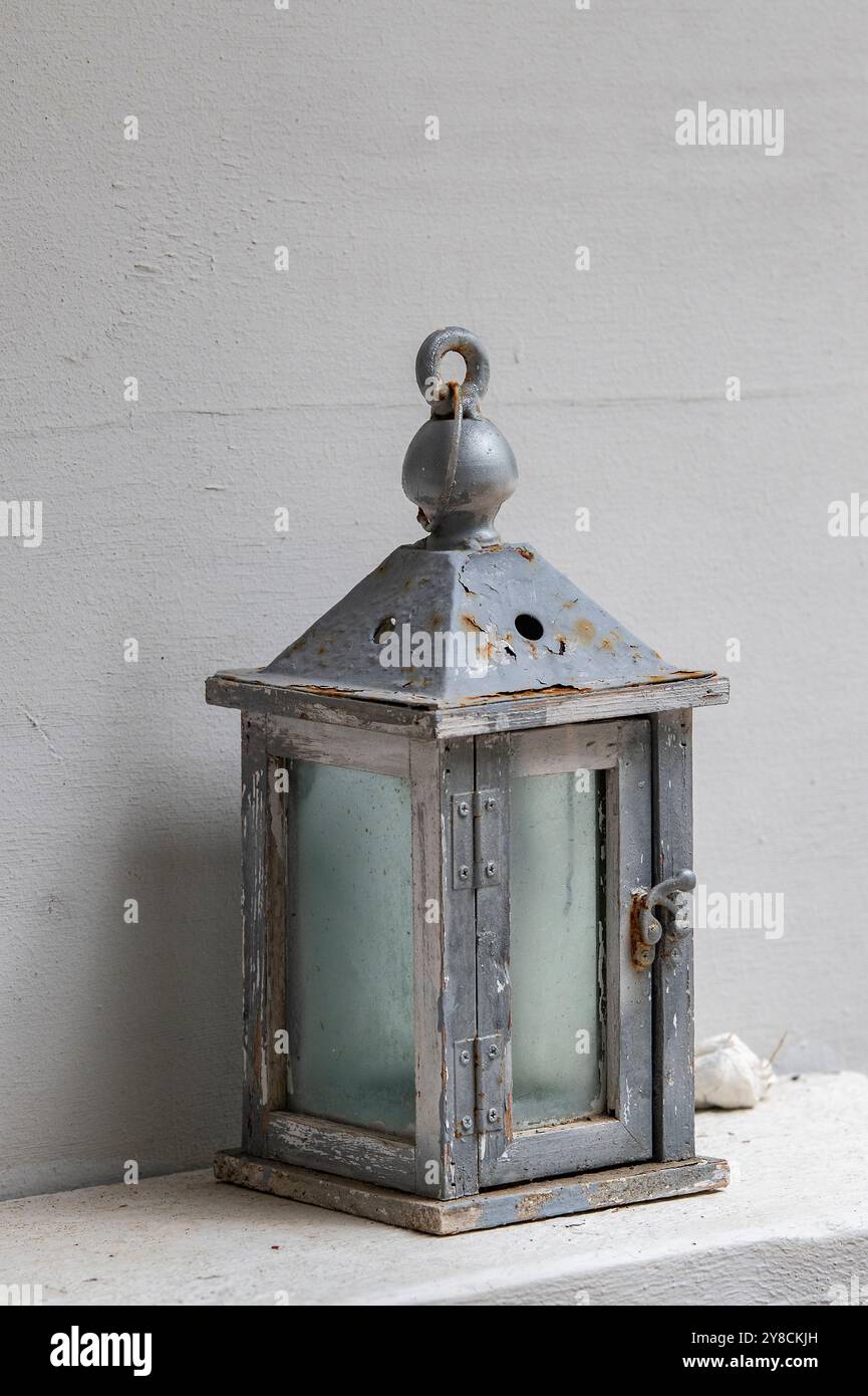 old rusty metal lantern on a shelf, corroded old fashioned style ...