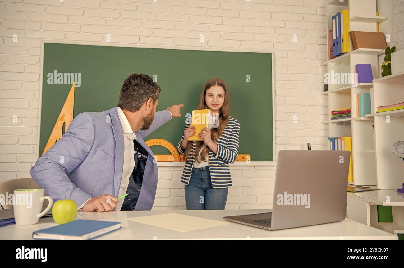 school teacher with selective focus of child at blackboard. pointing ...