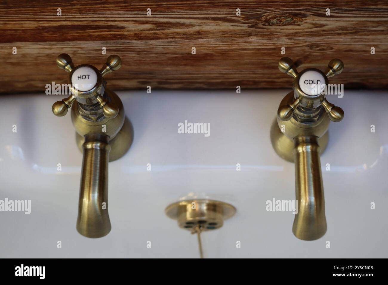 Cozy Rustic Bathroom with Flowing Vintage Brass Taps and Wooden Accents ...