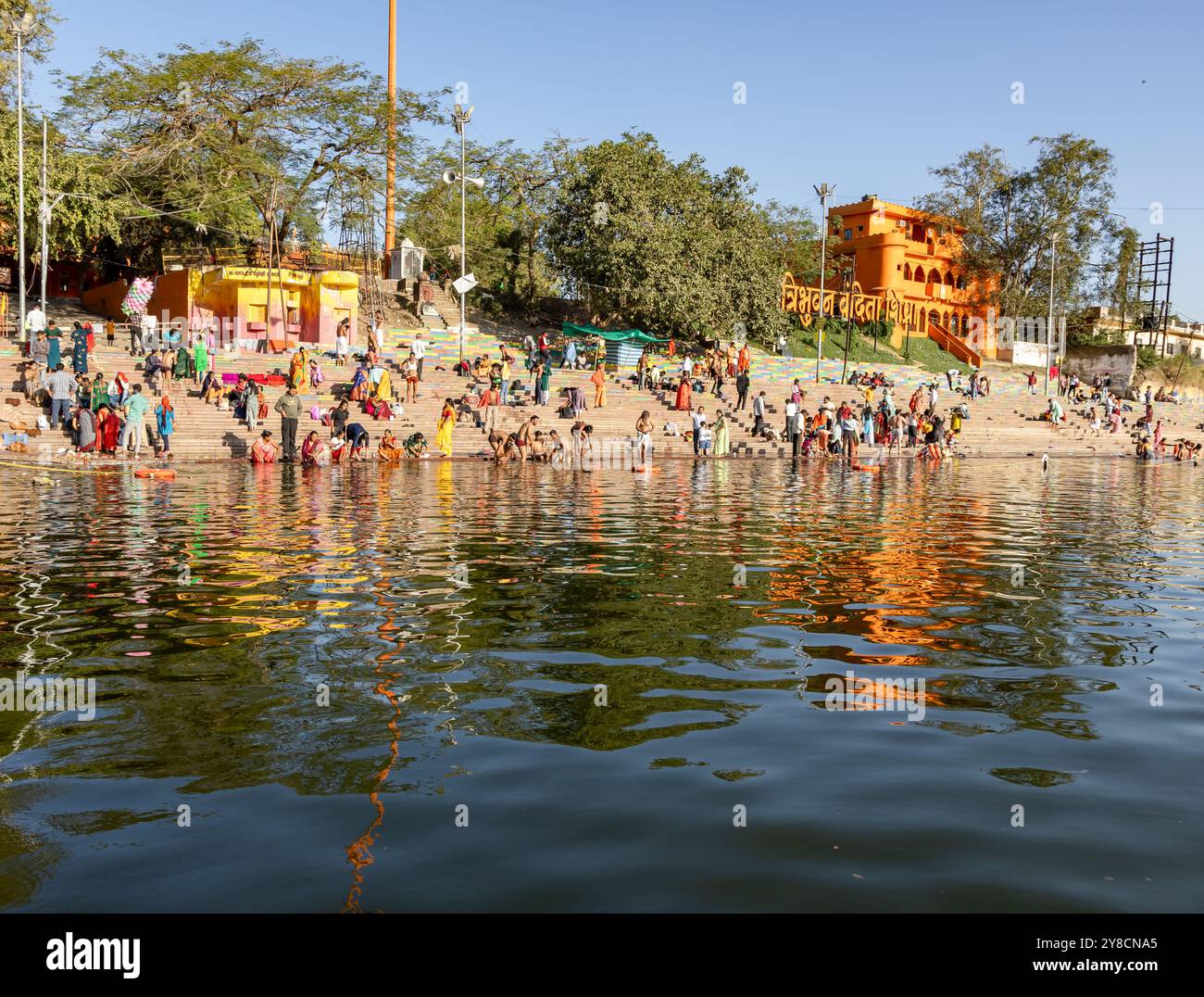 devotee bathing at pristine holy Shipra river shore at morning from ...