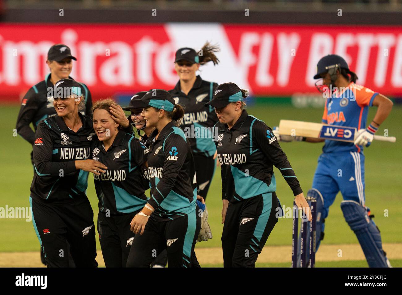 New Zealand team members congratulate Eden Carson, third from left, after she took the wicket of ...