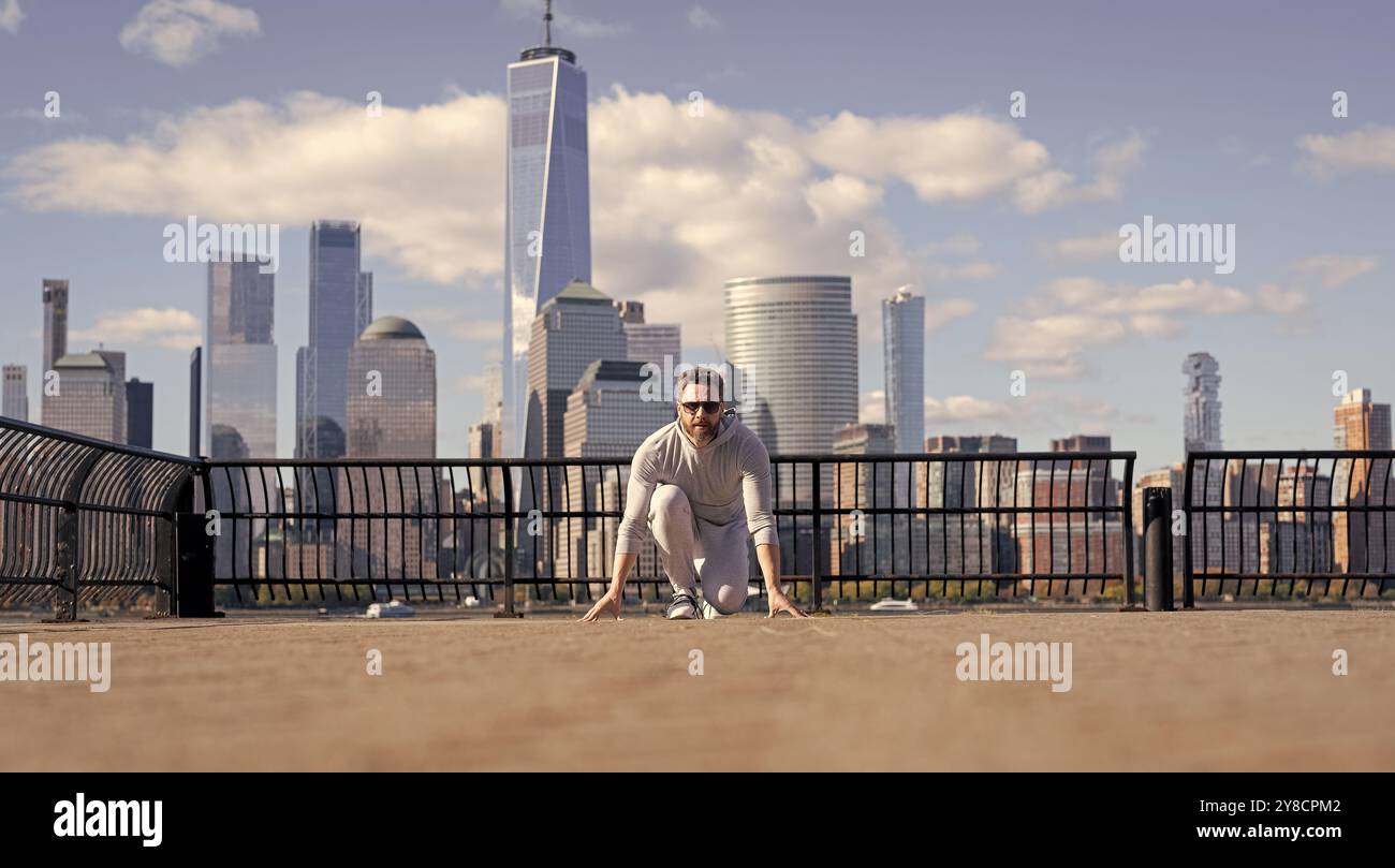 Athlete man ready for competition in running start pose in New York ...