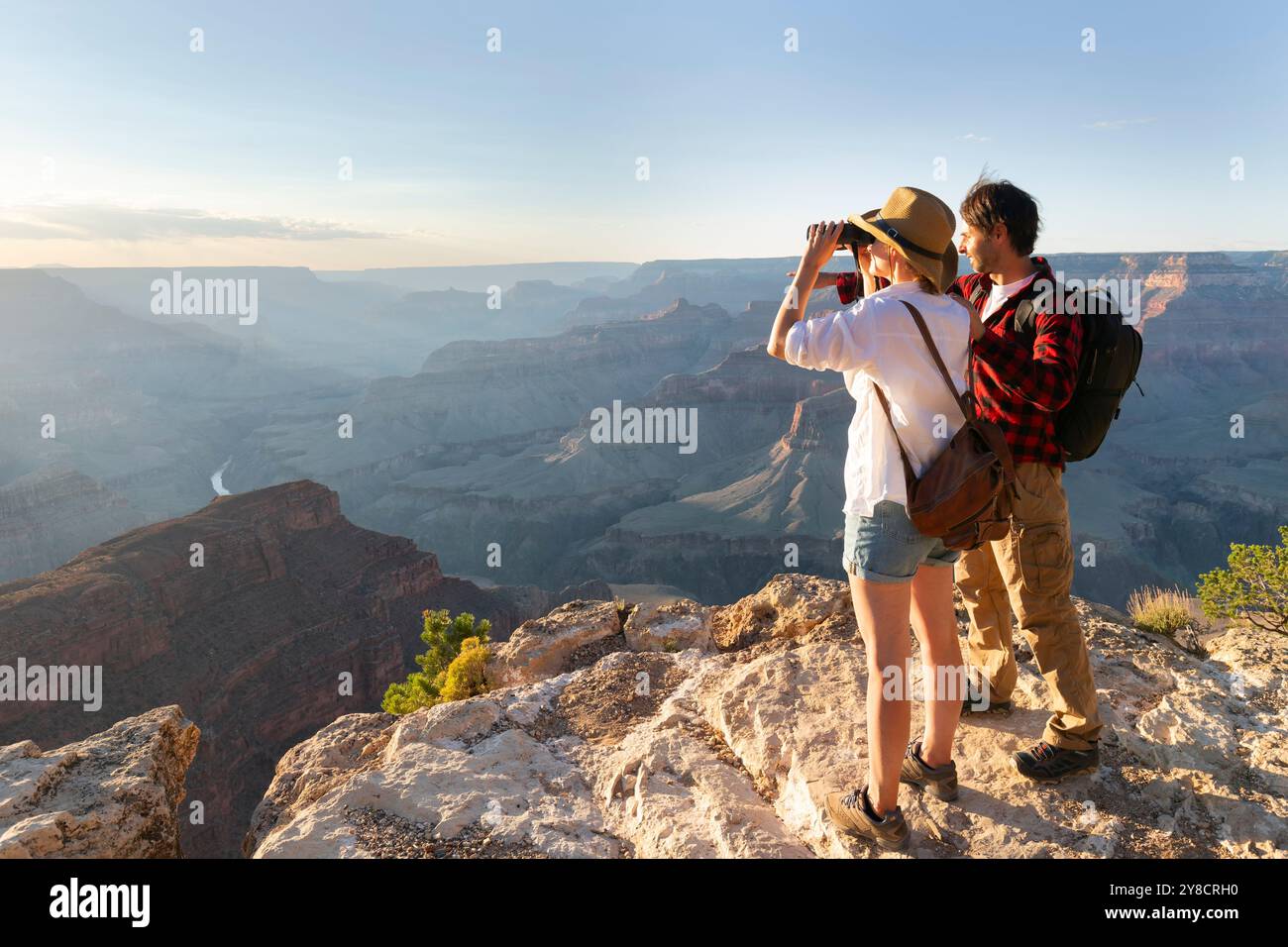 Portrait of happy young couple having fun on their hiking trip ...