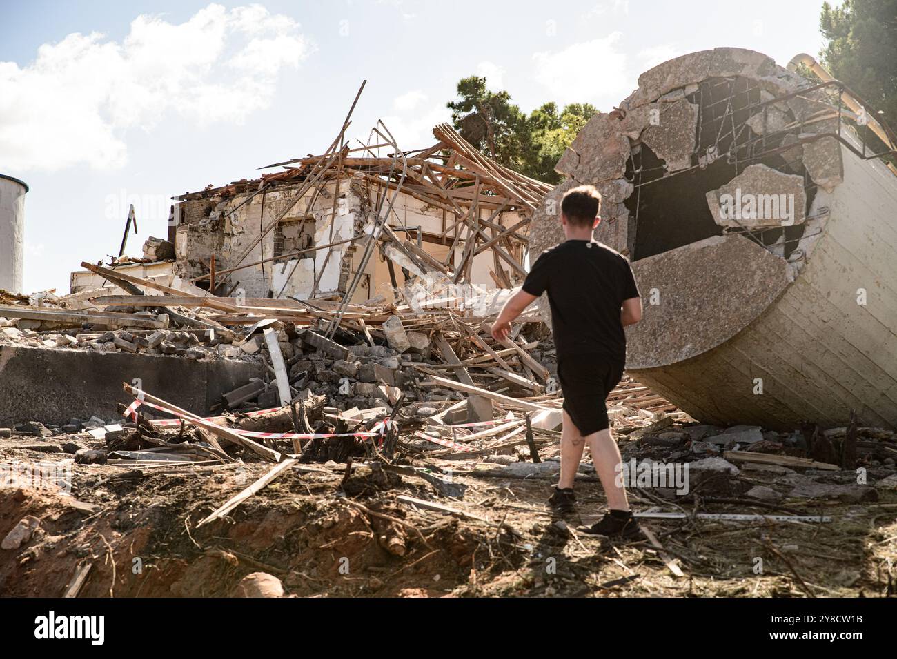 A man inspects a building that was destroyed by an Iranian missile. The ...