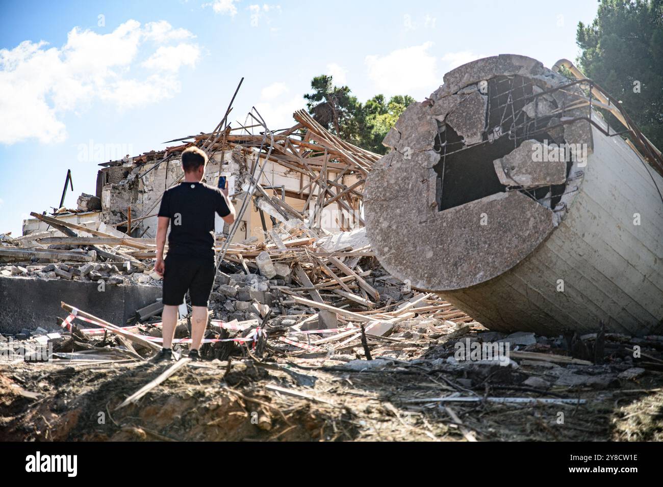 A man inspects a building that was destroyed by an Iranian missile. The ...