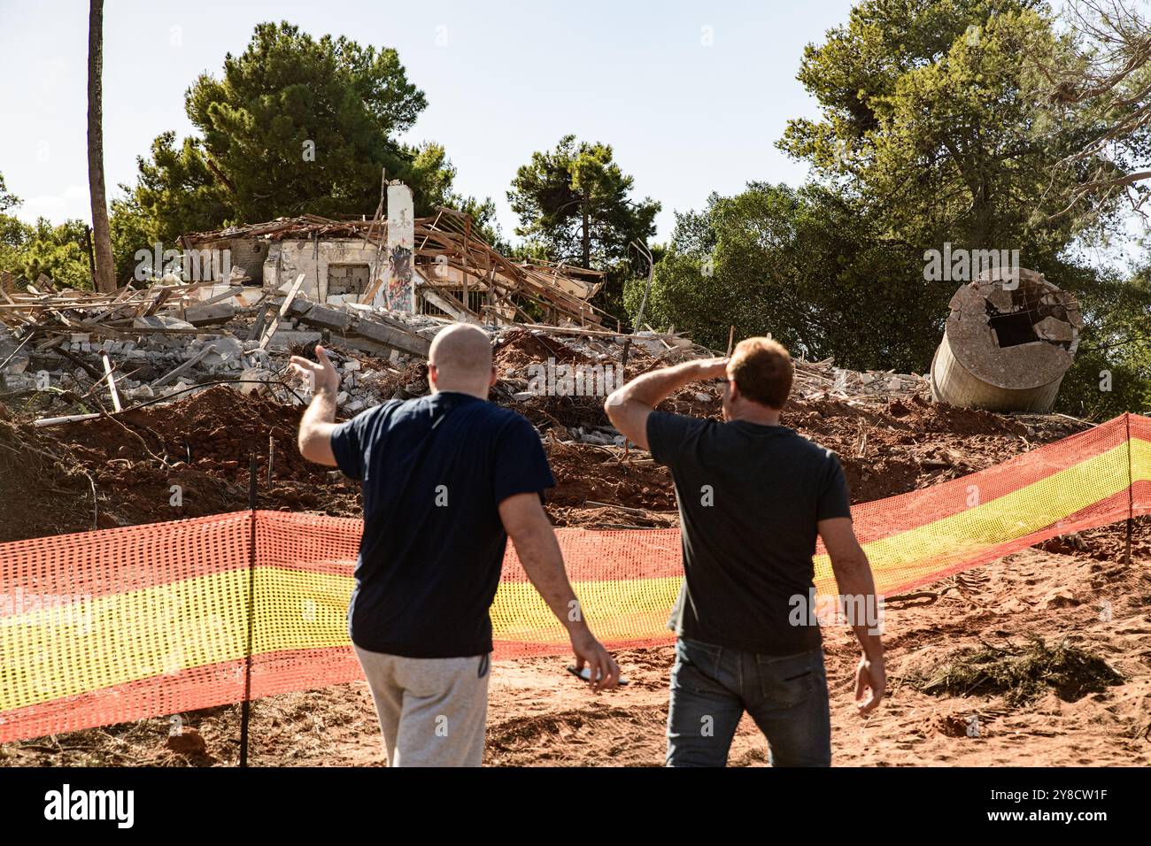 Israelis walk around a building that was destroyed by an Iranian ...