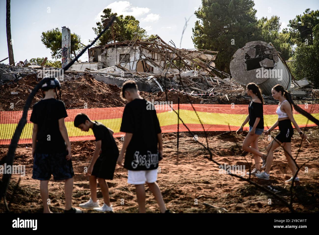 Israelis walk around a building that was destroyed by an Iranian ...