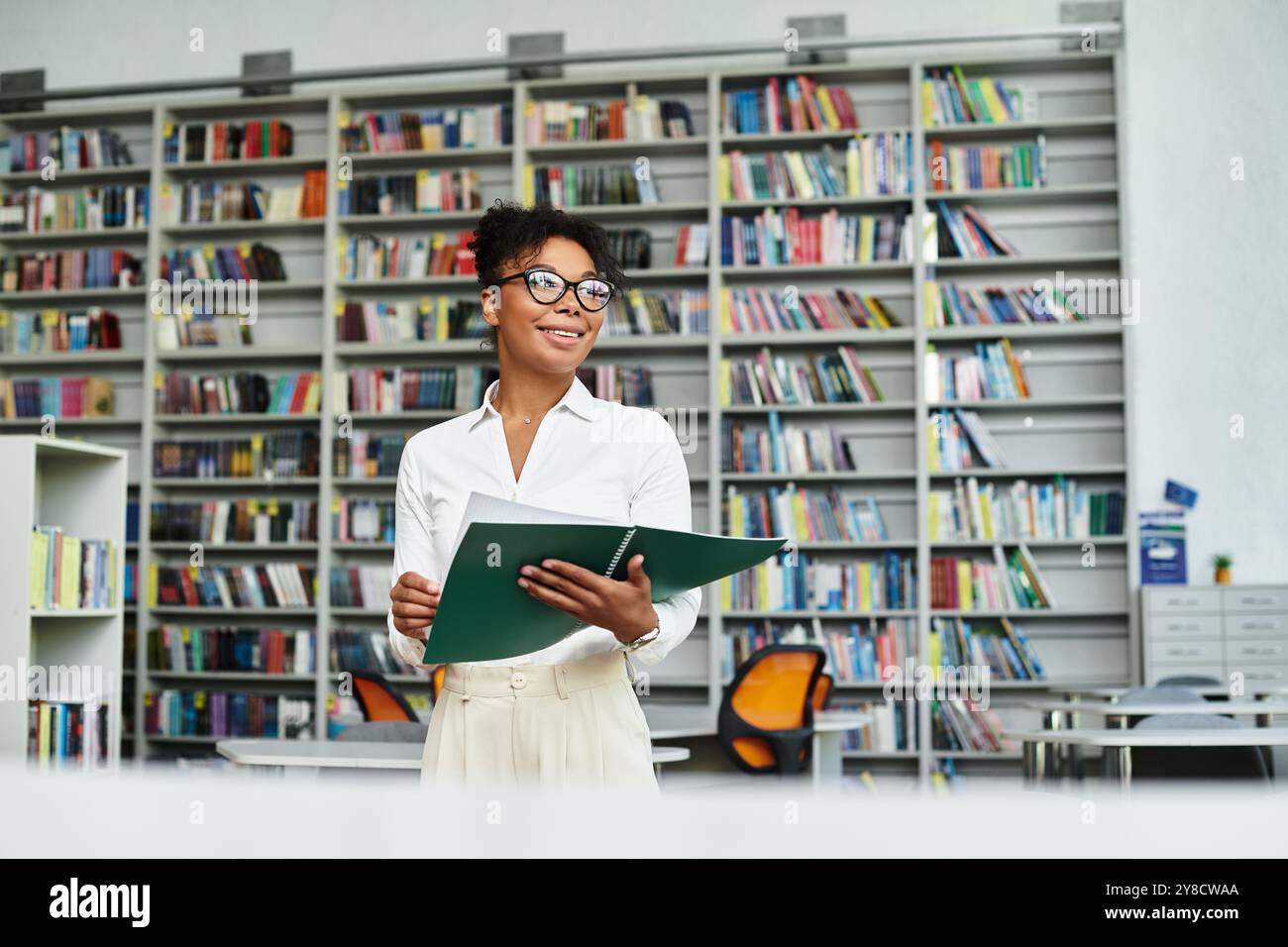 An enthusiastic teacher inspires students while standing confidently in ...