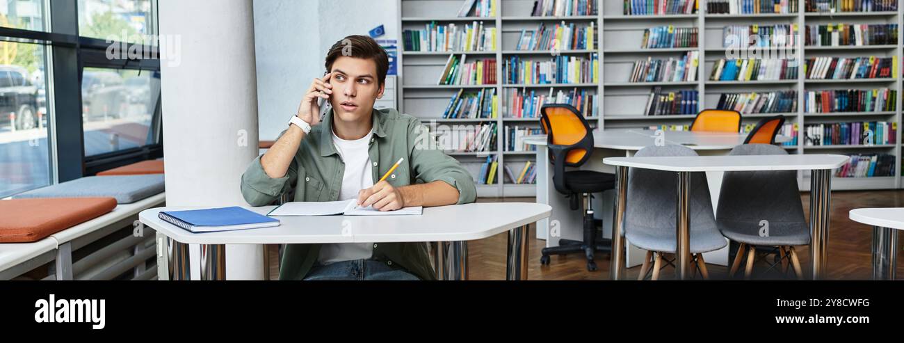 Handsome concentrated student studying his books in library Stock Photo ...