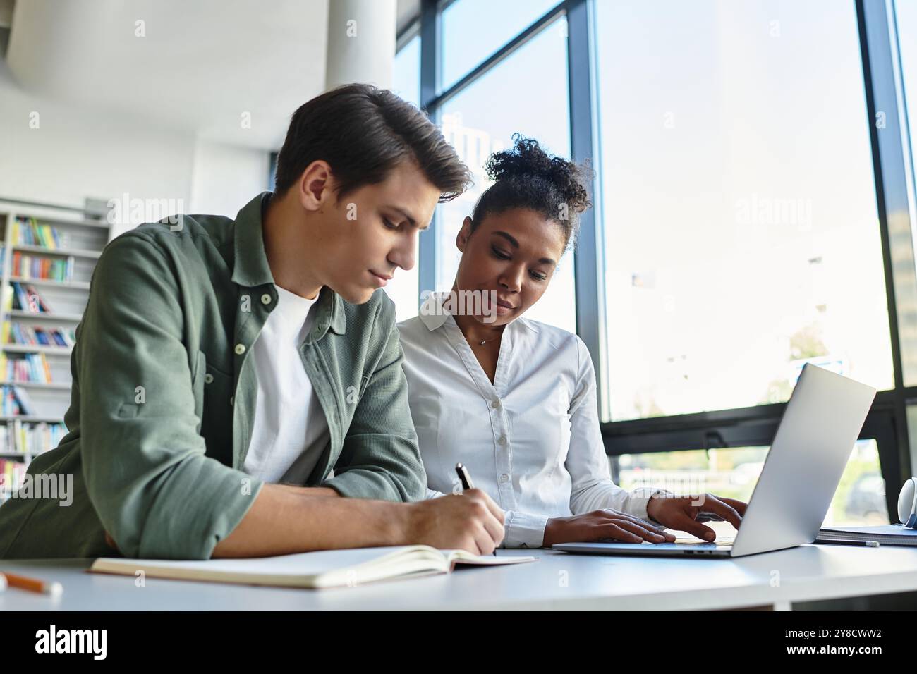 A beautiful teacher guides her young student in learning during an ...