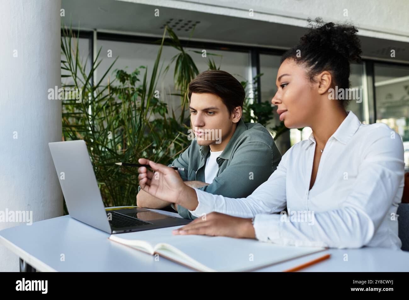 Student and his teacher collaborating at a study table in a vibrant ...