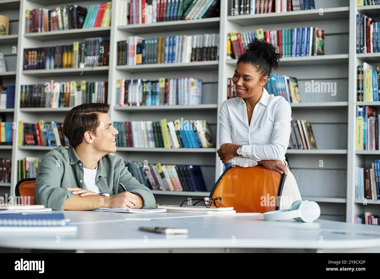 A dedicated teacher engages her student in a warm library, encouraging ...