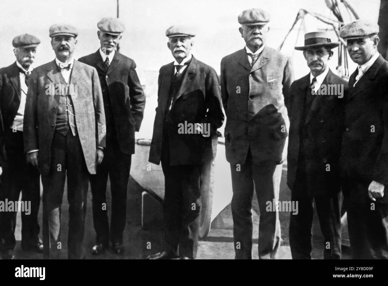 Henry Morrison Flagler (center), railroad and oil tycoon, standing with ...