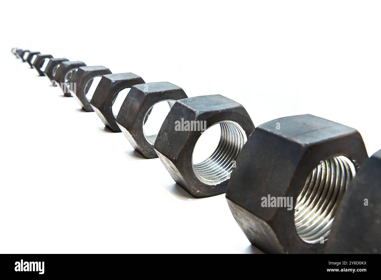 Row of threaded metal nuts on isolated white background Stock Photo - Alamy