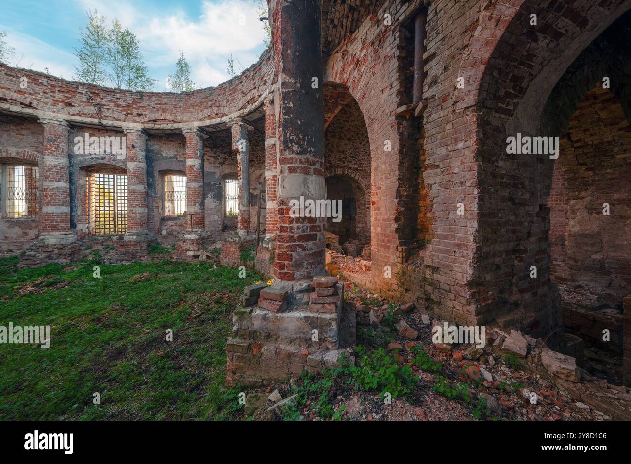 Brick ruins of an abandoned church. Columned hall with collapsed roof ...