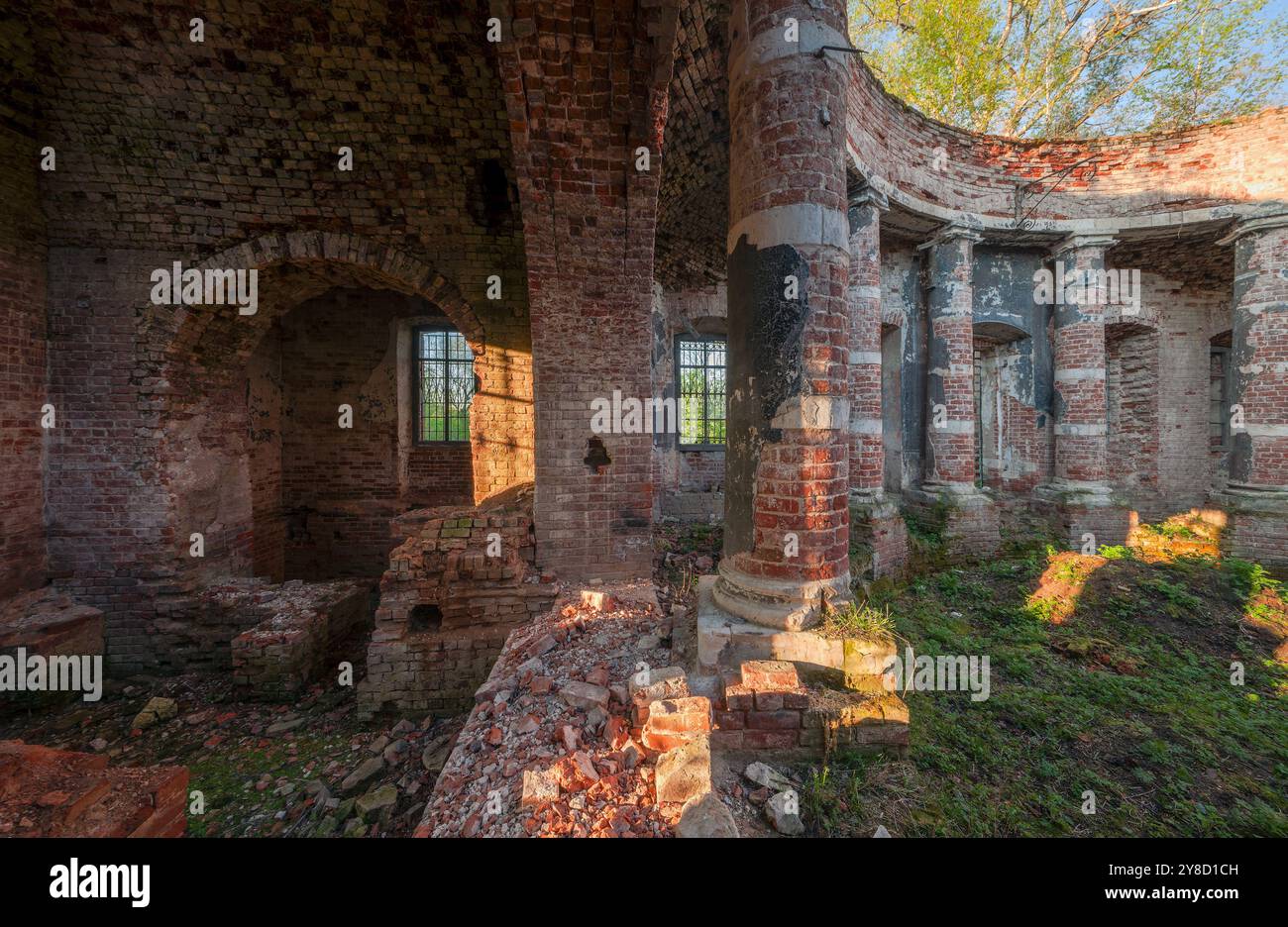 Brick ruins of an abandoned church. Columned hall with collapsed roof ...