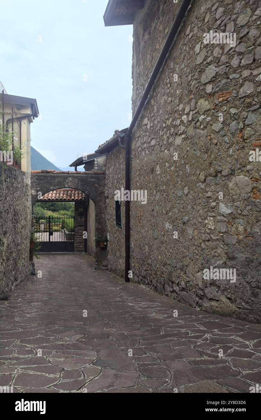 Narrow dead end alley between buildings that leads to a closed gate ...