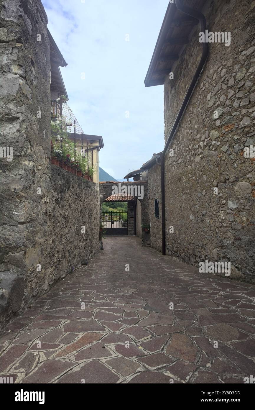 Narrow dead end alley between buildings that leads to a closed gate ...