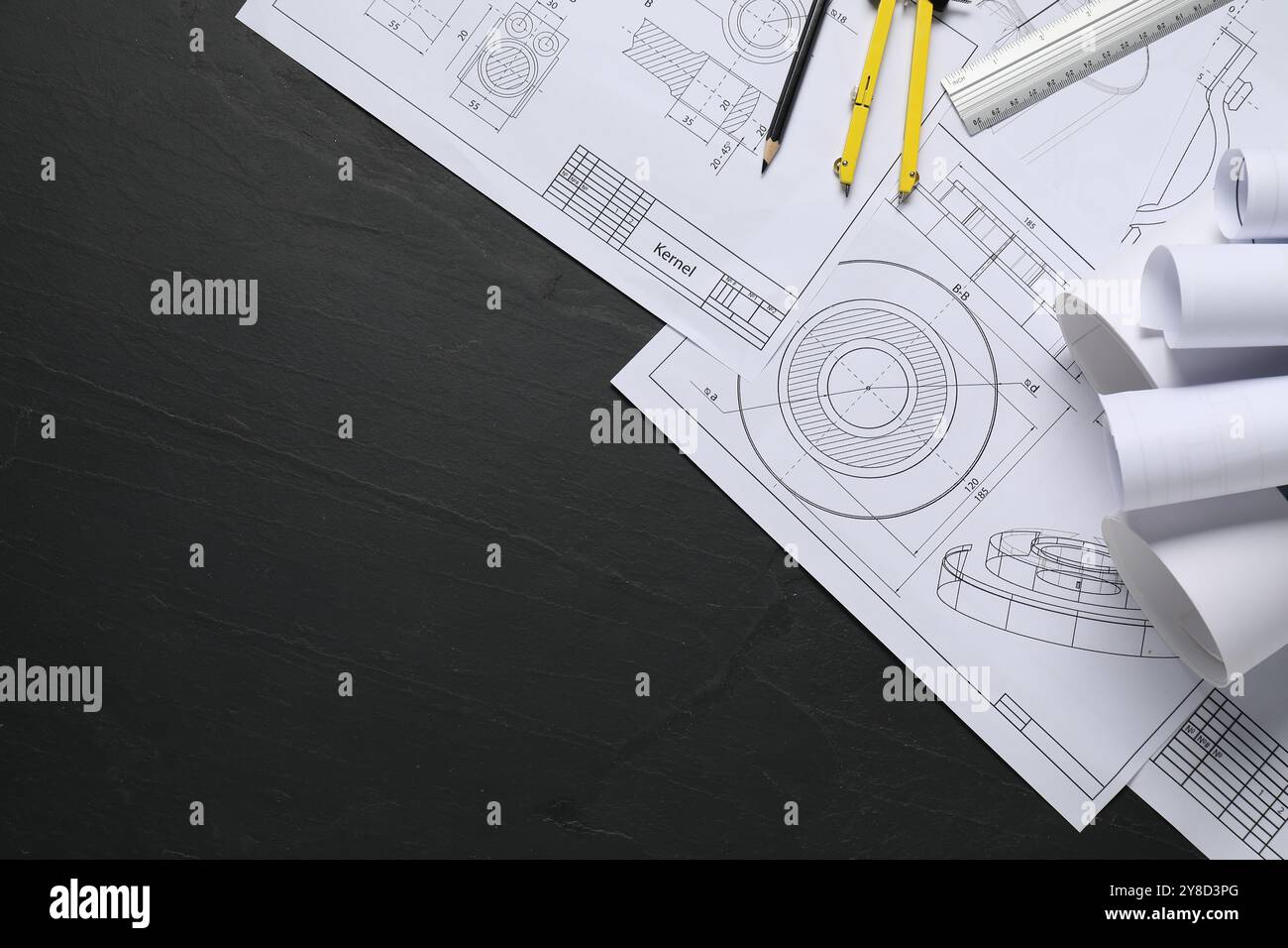 Different engineering drawings, ruler, divider and pencil on grey ...