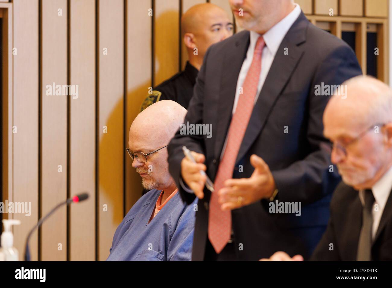 Portland, USA. 03rd Oct, 2024. Robert Plympton sits next to defense ...