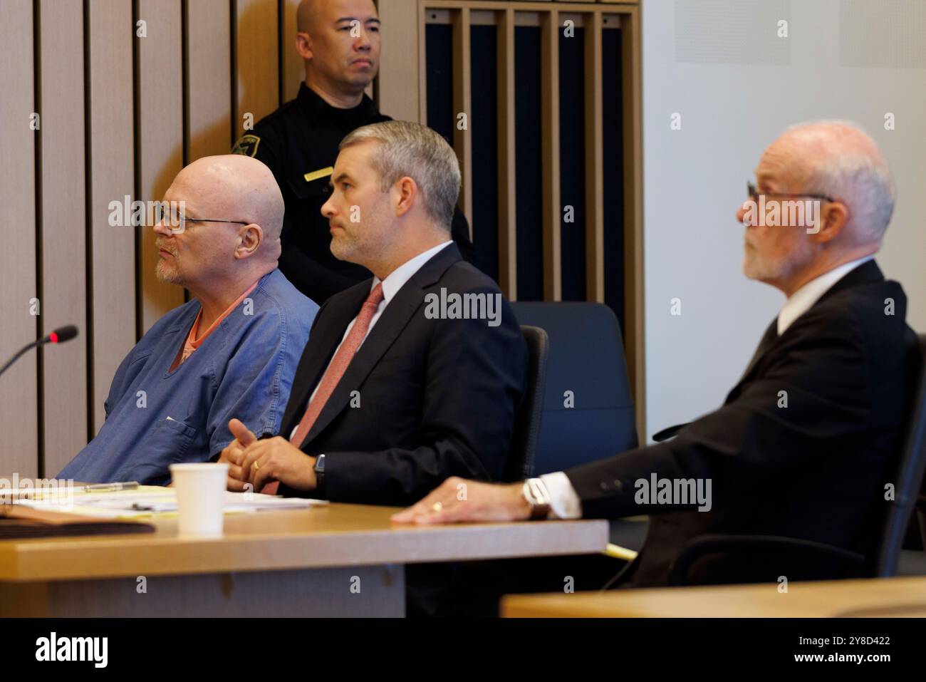 Portland, USA. 03rd Oct, 2024. Robert Plympton sits next to defense ...