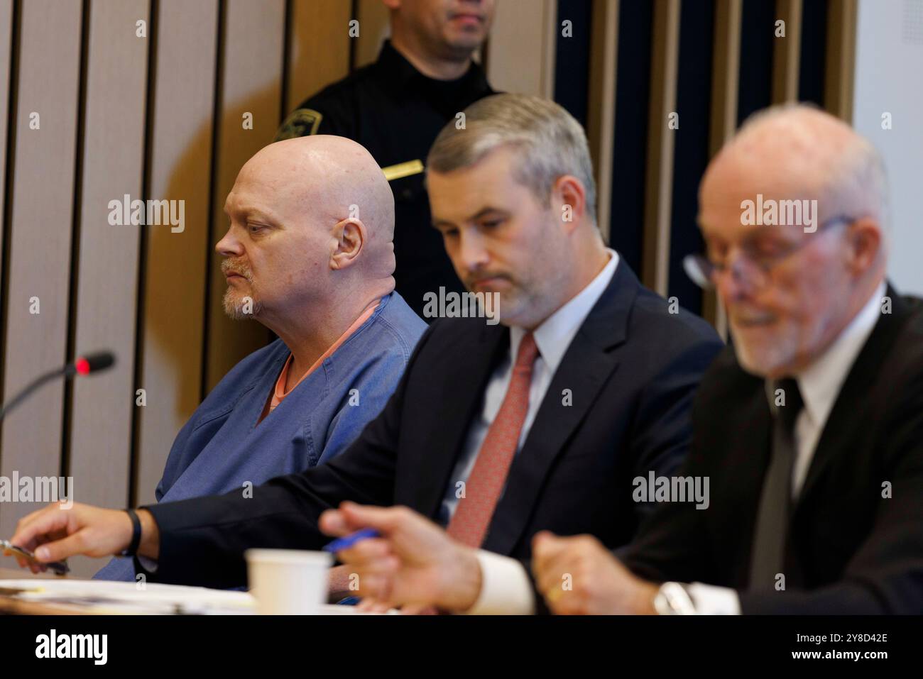 Portland, USA. 03rd Oct, 2024. Robert Plympton sits next to defense ...