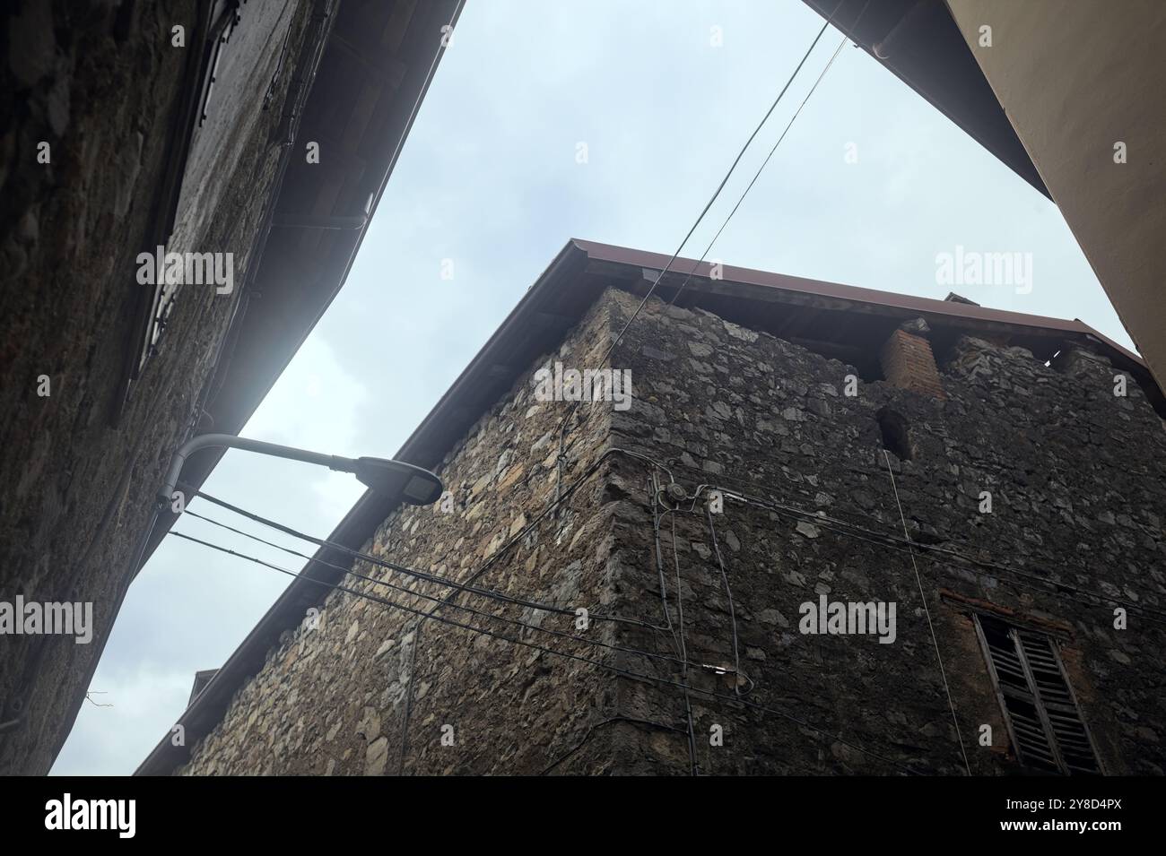 Historic stone buildings in an italian town with the sky as background ...