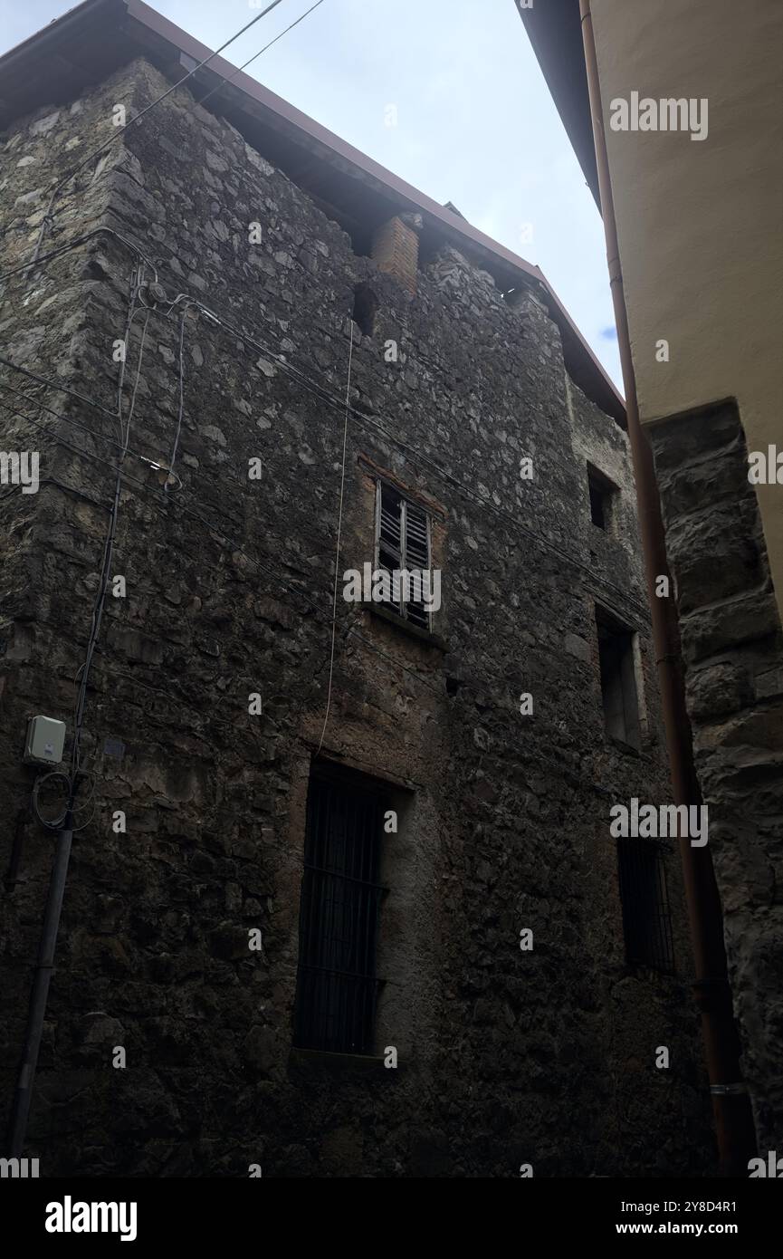 Dead end narrow alley between buildings with stone walls in a town ...