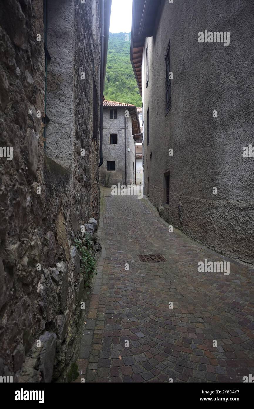 Dead end narrow alley between buildings with stone walls in a town ...