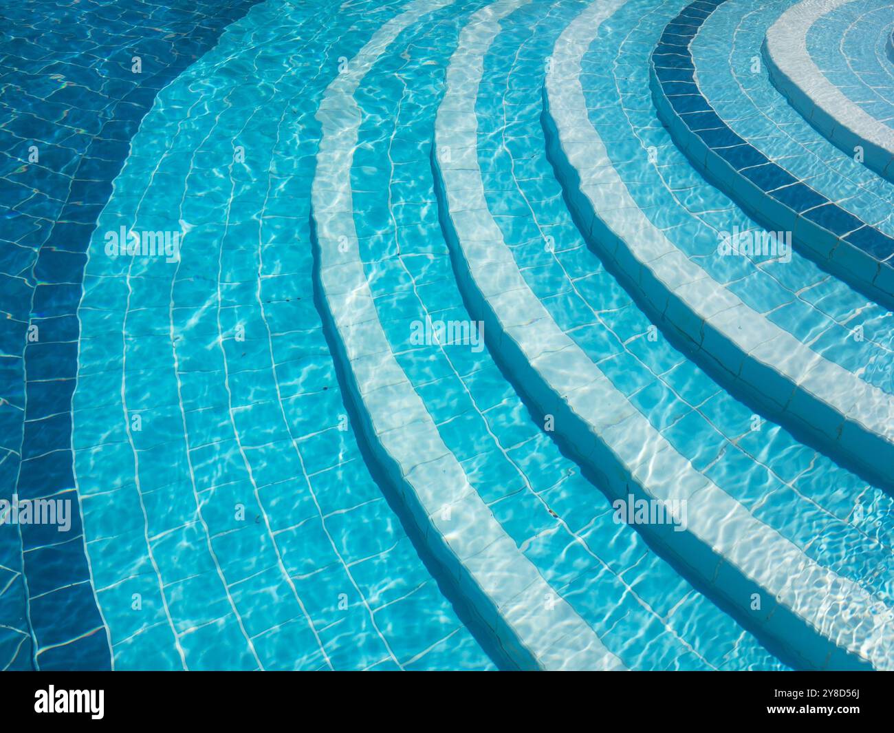 Swimming pool background with distorted tiles and stairs below water ...