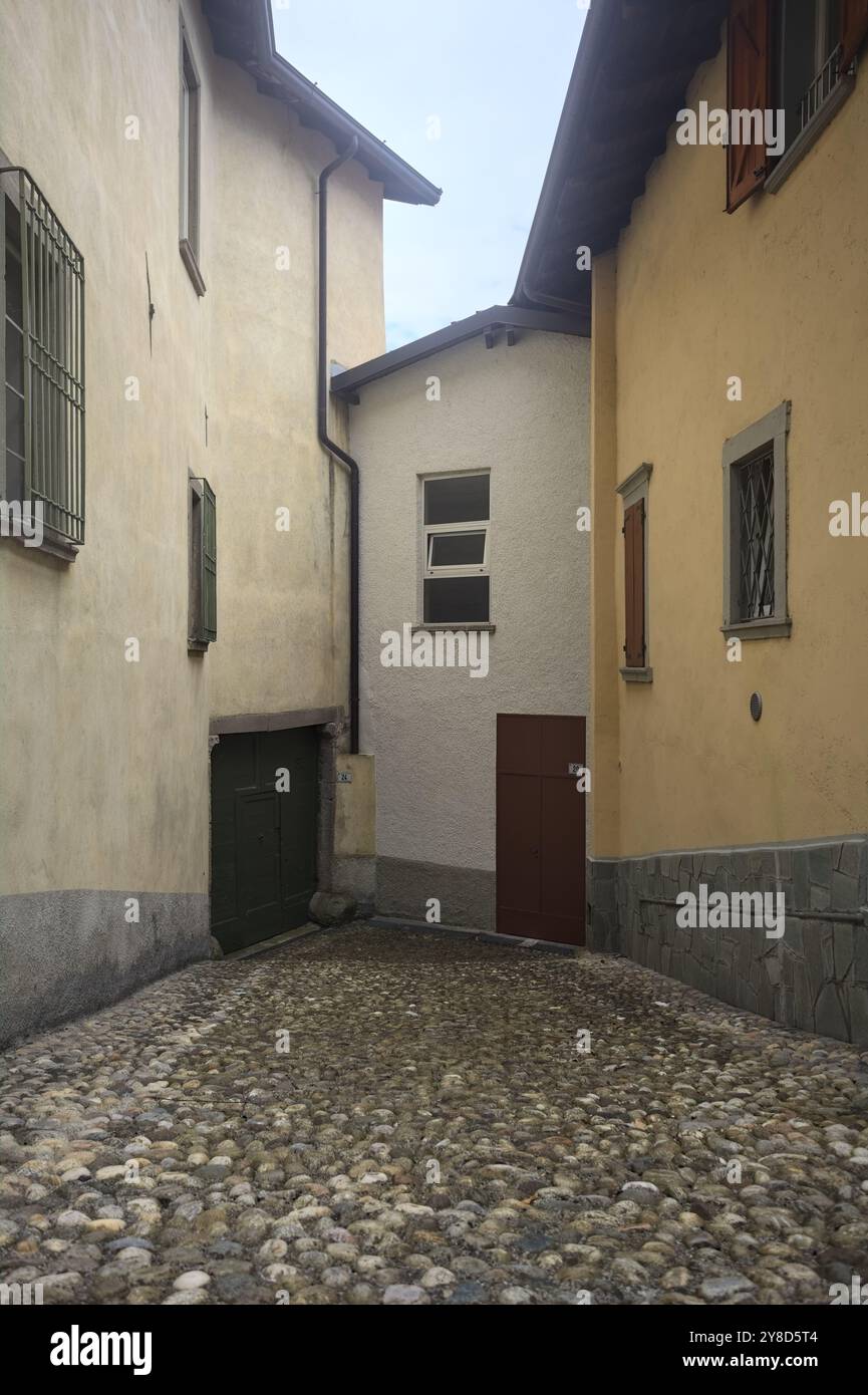 Narrow dead end alley between buildings that leads to a closed gate ...