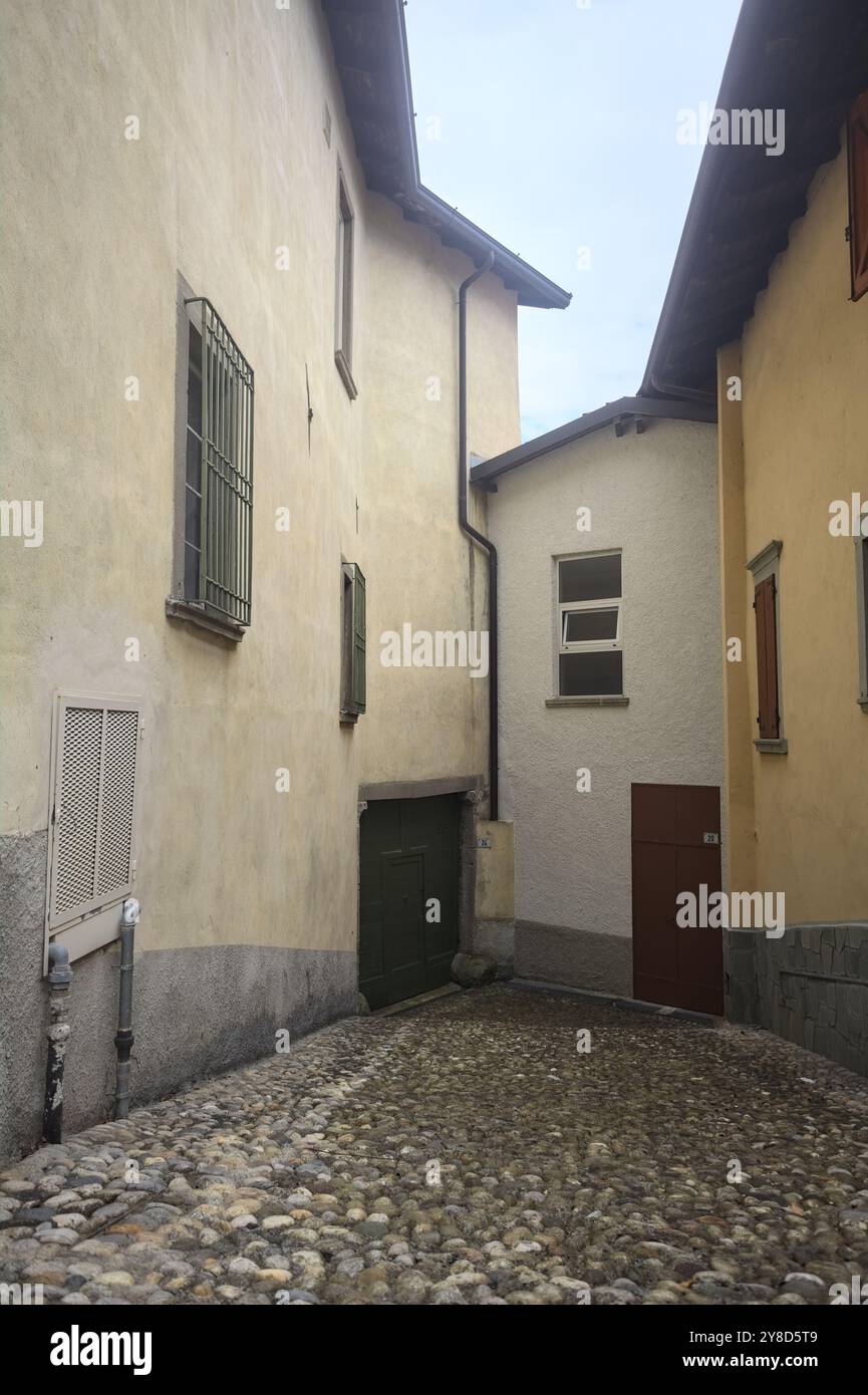 Narrow dead end alley between buildings that leads to a closed gate ...
