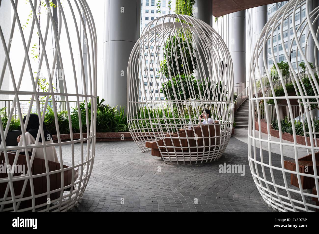 01.08.2023, Singapore, Republic of Singapore, Asia - People sit in bird ...