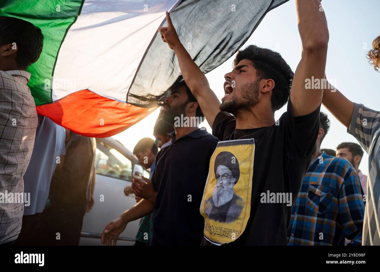 A Kashmiri Shia Muslim man shouts slogans while wearing a T-shirt ...