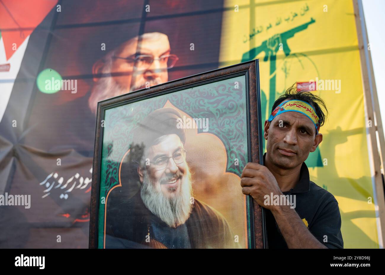 A Kashmiri Shia Muslim man looks on as he holds a photograph of Sayyed ...