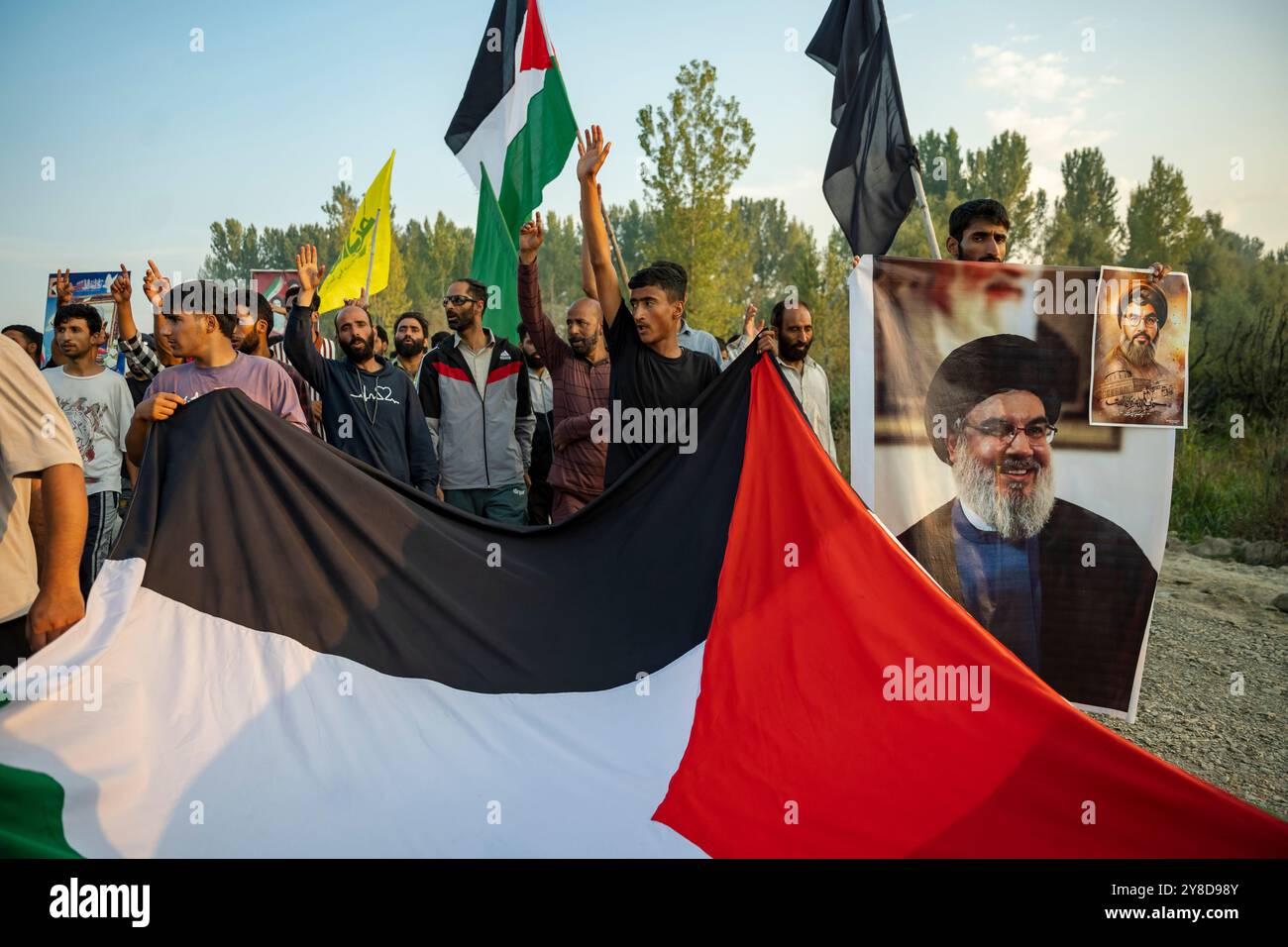 Kashmiri Shia Muslims hold Palestinian flags and photographs of Sayyed ...