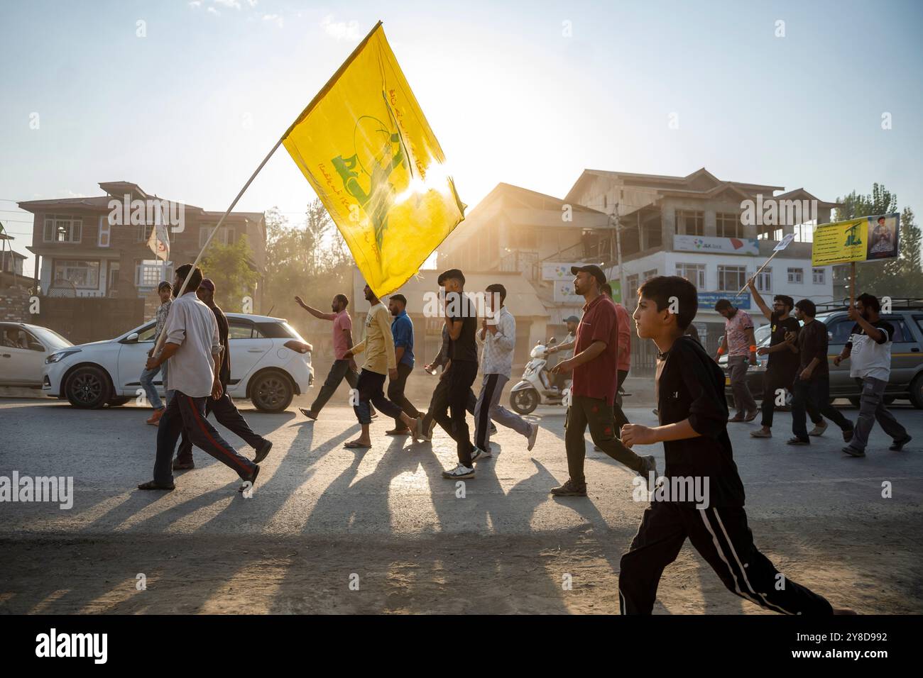 Kashmiri Shia Muslims walk with a flag of Hezbollah during a protest ...