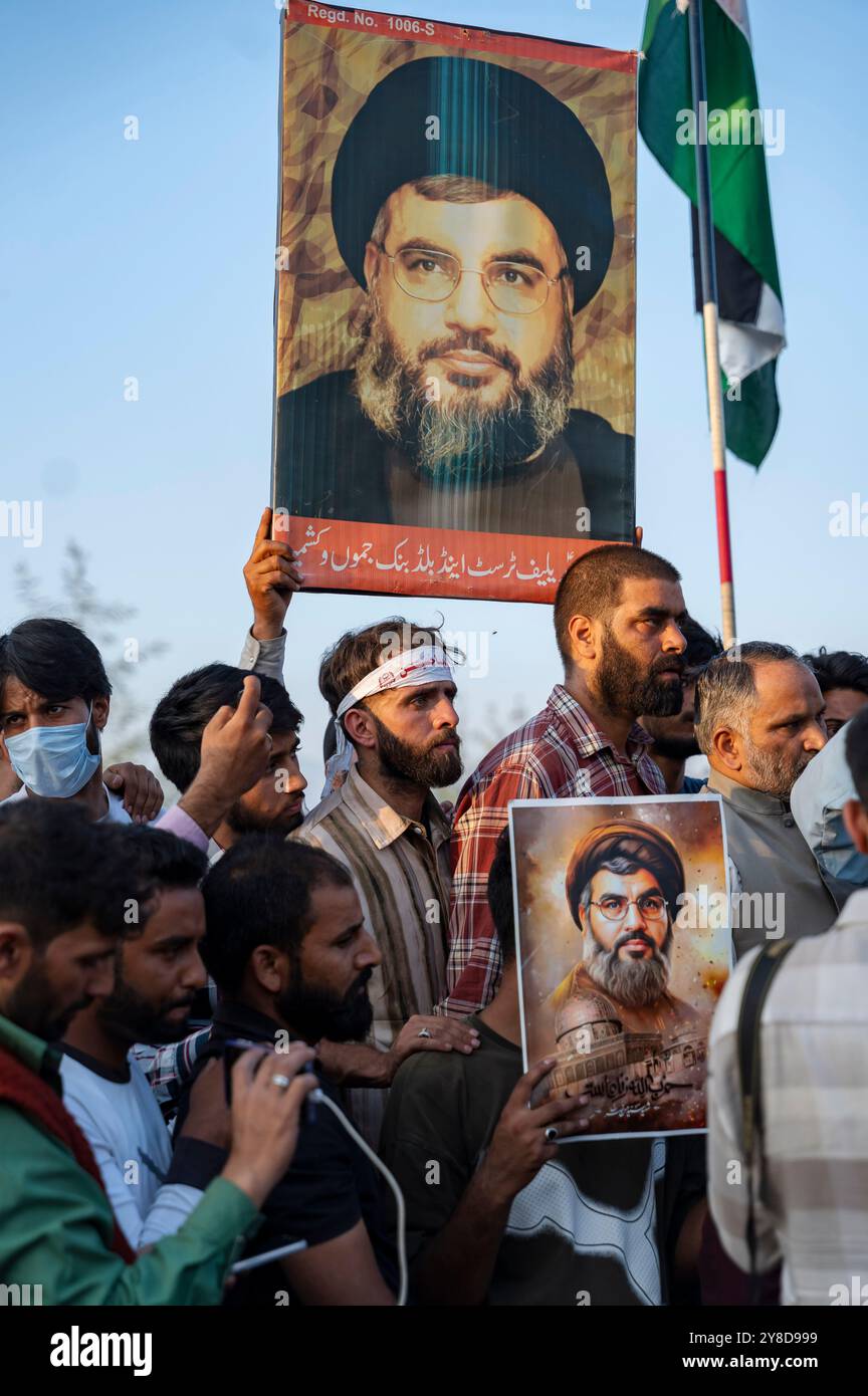 Kashmiri Shia Muslims listens to a religious speaker while holding ...