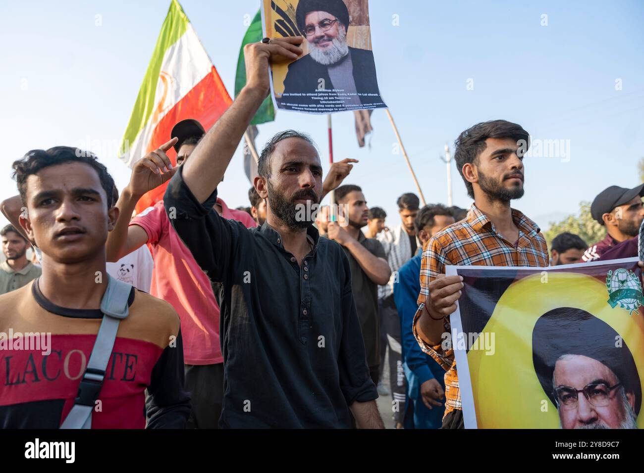 A Kashmiri Shia Muslim man walks with a photograph of Sayyed Hassan ...