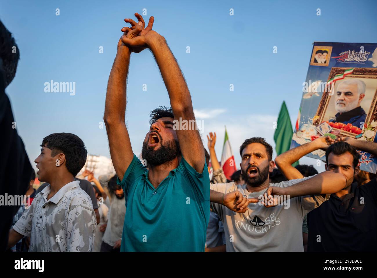 Kashmiri Shia Muslims shout slogans while holding a photograph of ...