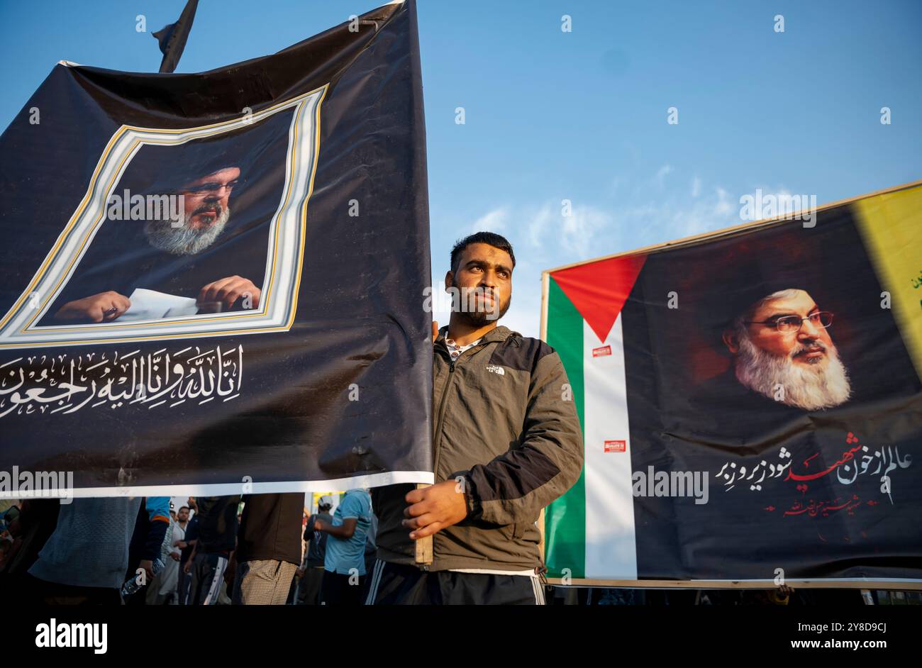 A Kashmiri Shia Muslim man holds a poster depicting Sayyed Hassan ...