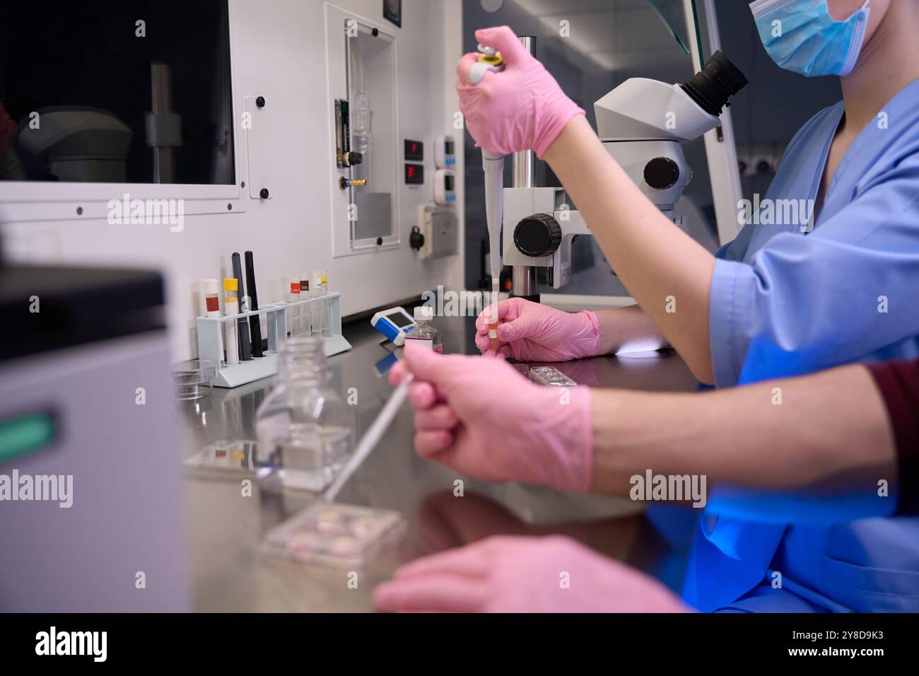 Female embryologist conducting a precision lab process Stock Photo - Alamy