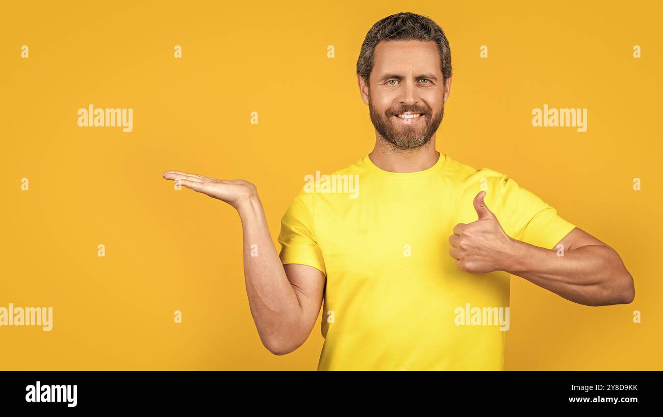 happy man presenting advertisement on background, thumb up. man ...