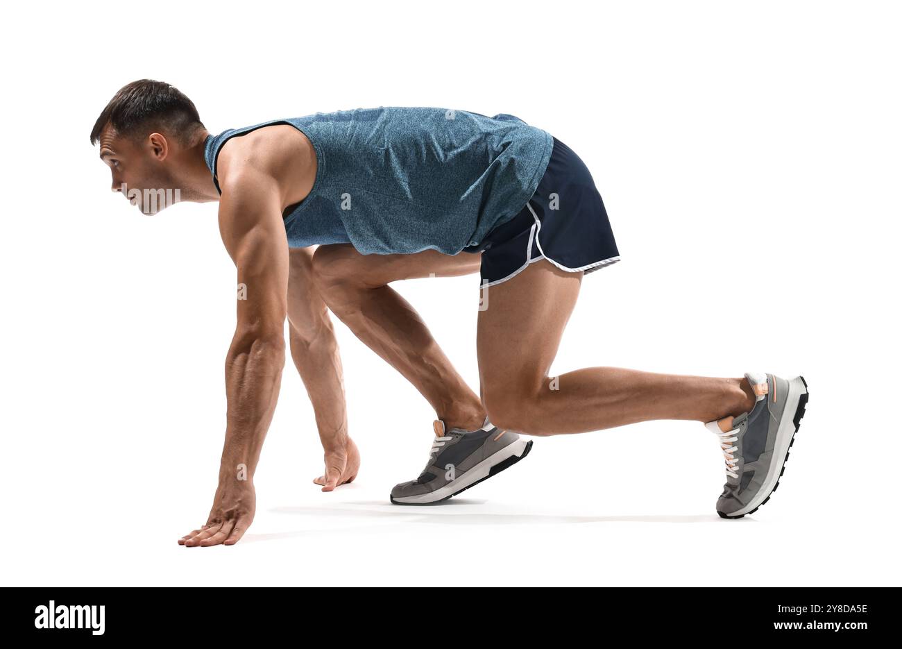Sportsman in starting position for run on white background Stock Photo ...