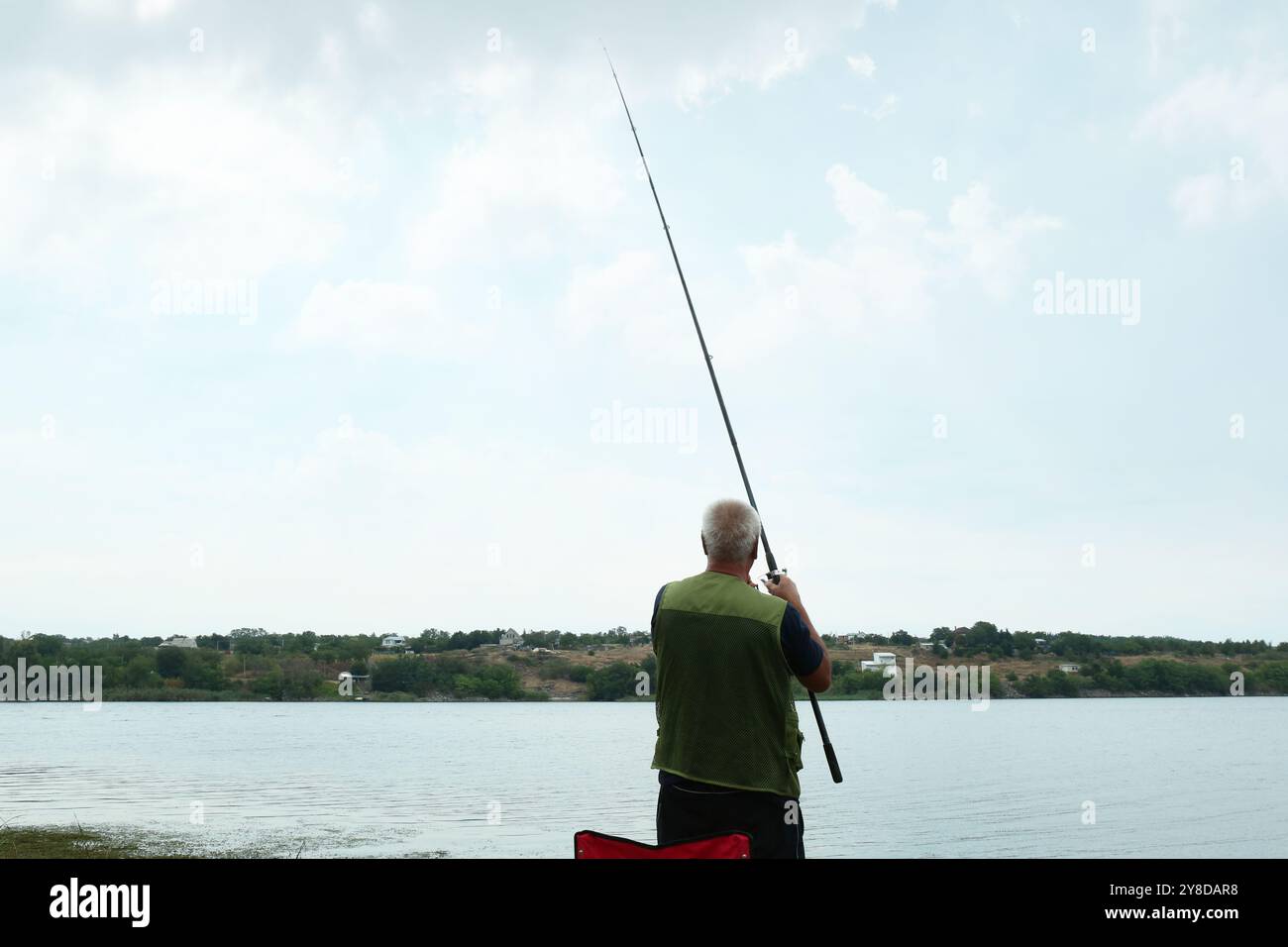 Back view man holding fishing hi-res stock photography and images - Alamy