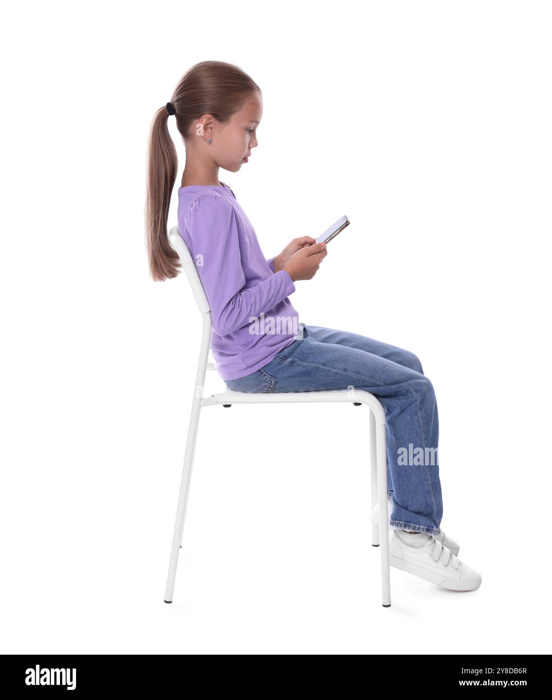Girl with correct posture and smartphone sitting on white background ...