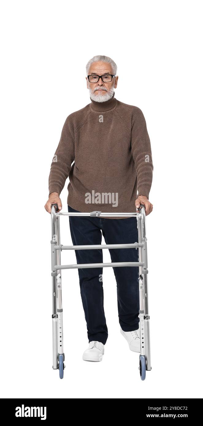 Senior man using walking frame on white background Stock Photo - Alamy