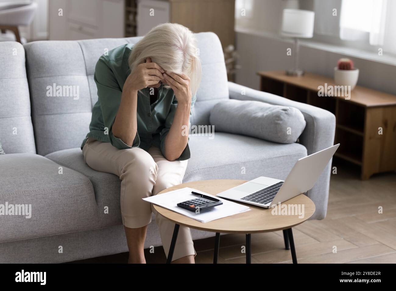 Elderly woman feels stressed due to financial strain over repayment ...