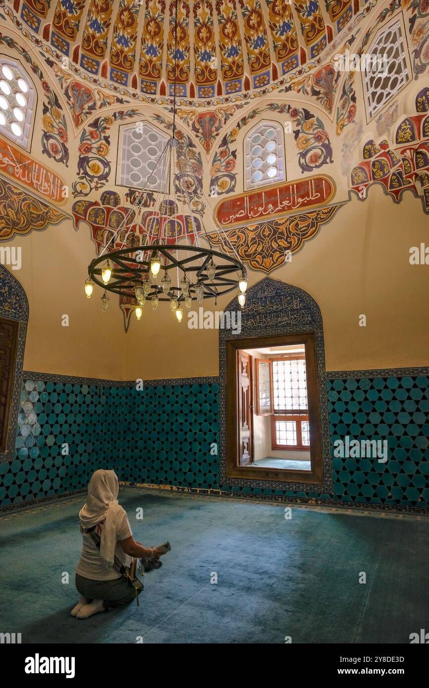 Bursa, Turkey - September 8, 2024: A woman praying in the Green Mosque ...